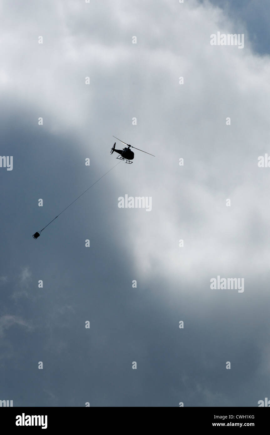 A helicopter carrying a load on a cable hi-res stock photography and ...