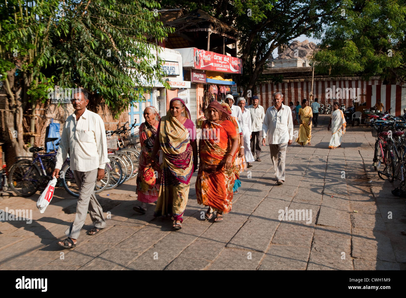 Families heading to the temple in Hampi Bazaar Stock Photo - Alamy