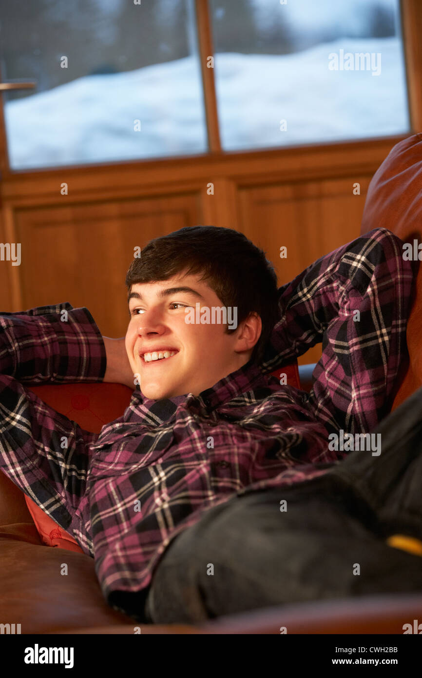 Teenage Boy Relaxing On Sofa Stock Photo - Alamy