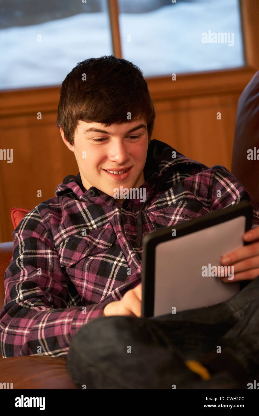 Teenage Boy Relaxing On Sofa With Tablet Computer Stock Photo - Alamy