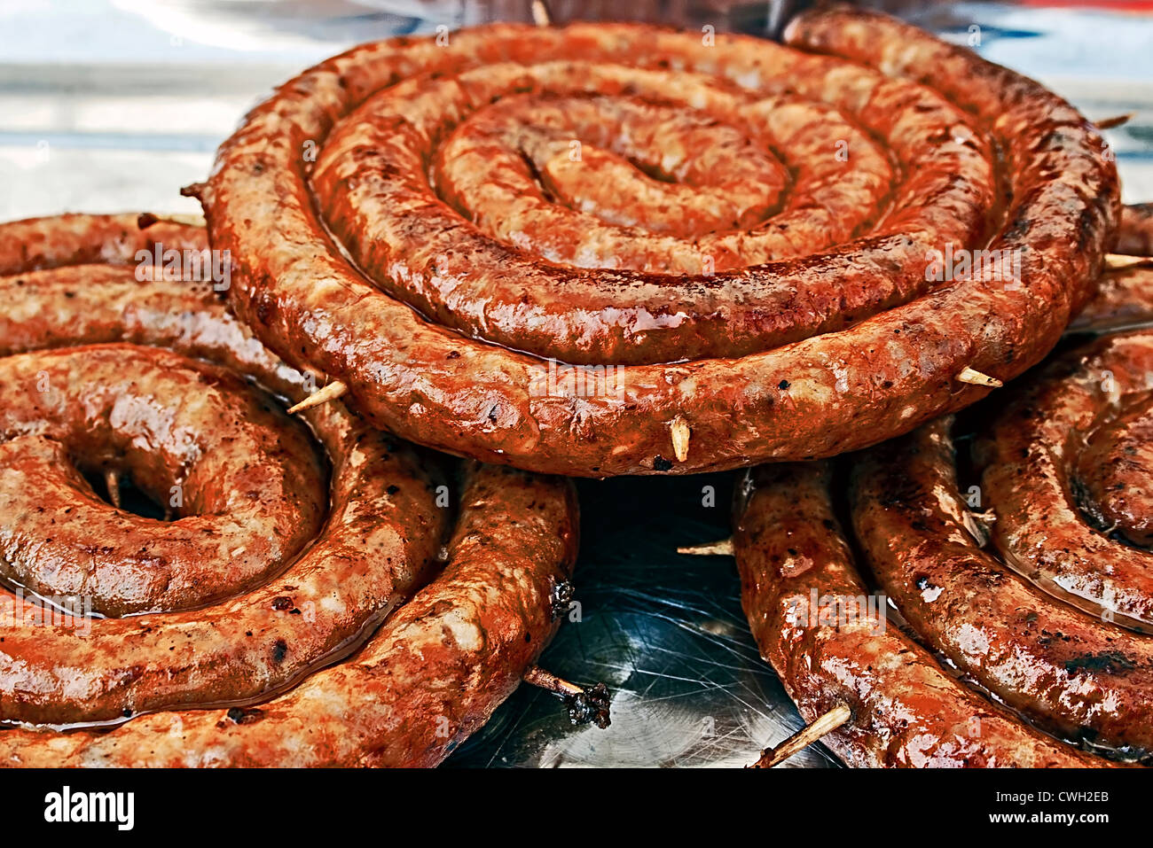 Fried sausages roll, secure with wooden rods Stock Photo - Alamy