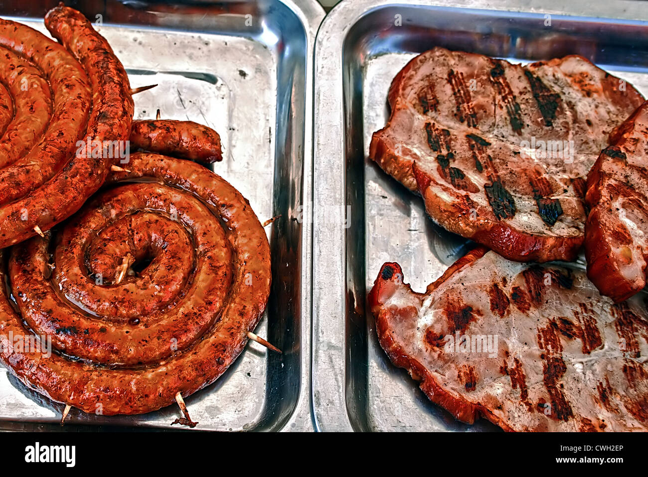 Toasted ham and fried sausages rolled, secure with wooden rods Stock ...