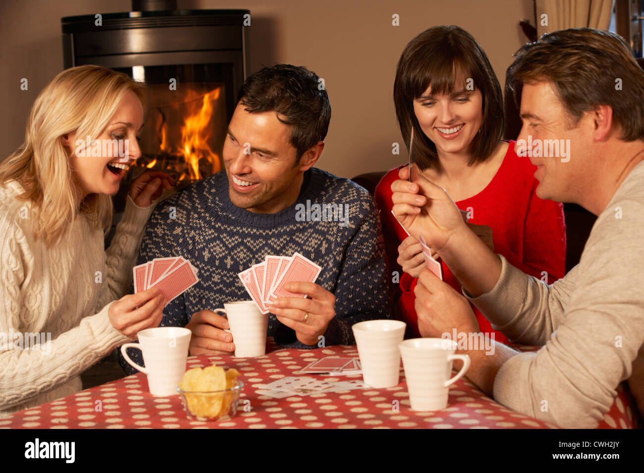 Group Of Middle Aged Couples Playing Cards Together Stock Photo - Alamy
