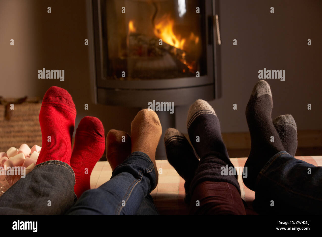 Close Up Of Familys Feet Relaxing By Cosy Log Fire With Marshmallows ...