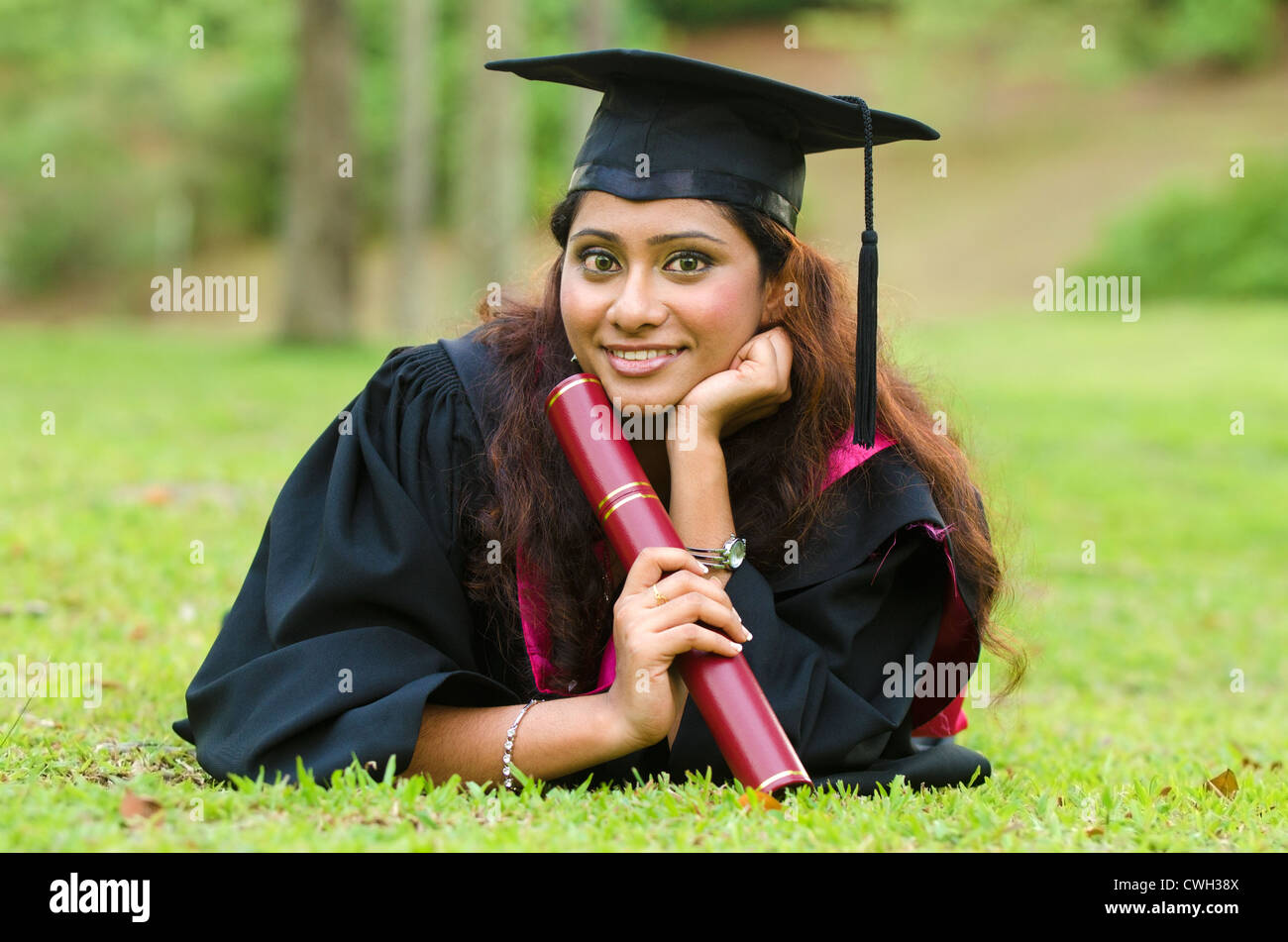 indian female graduate laying Stock Photo - Alamy