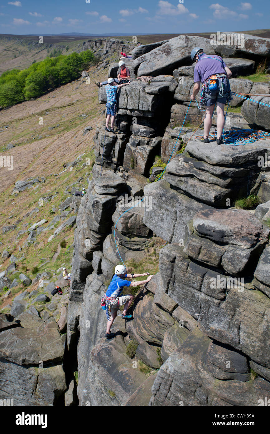 Rock climbers on Stanage Edge in the Peak District Derbyshire England ...