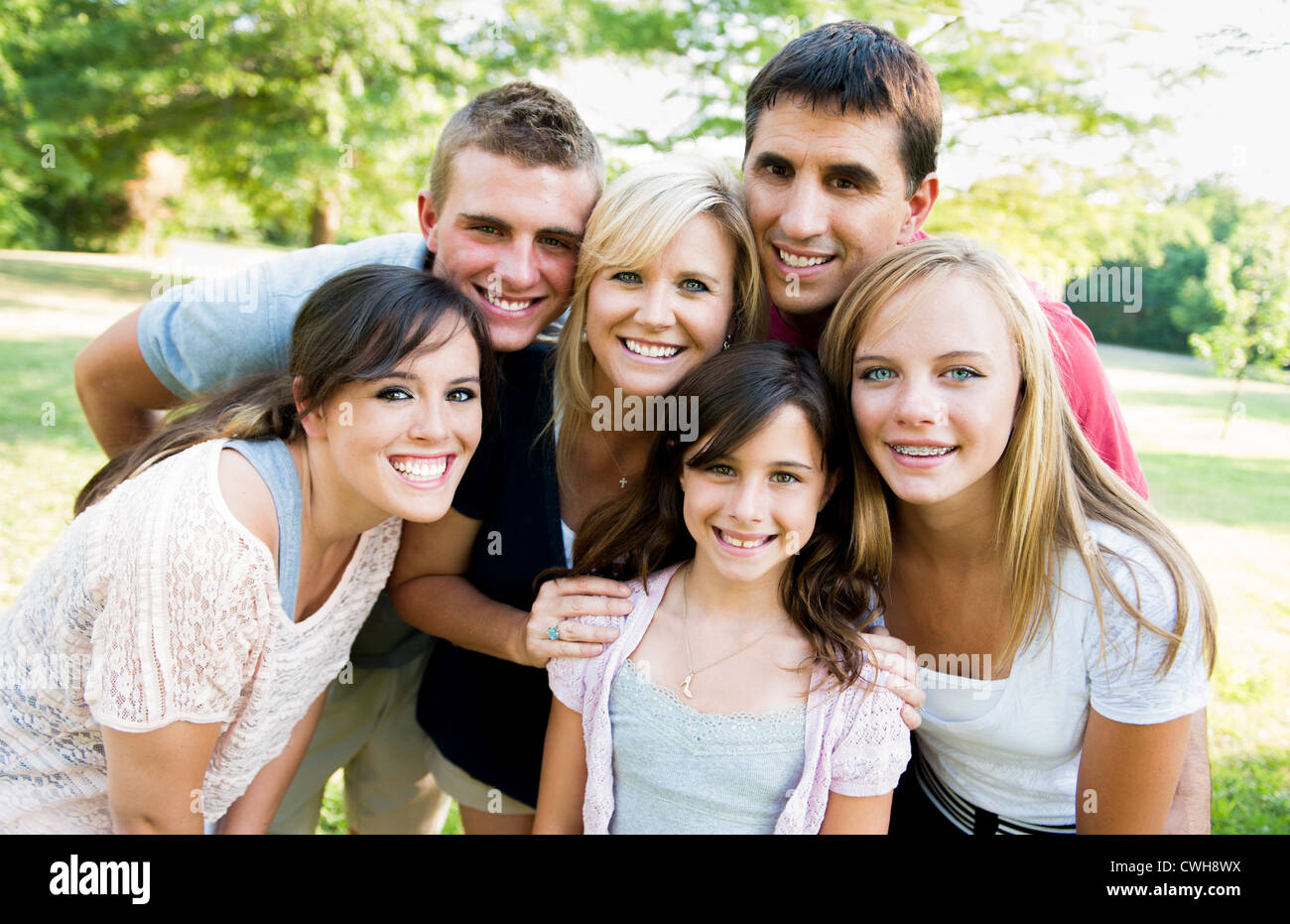 Large family gathered together smiling at the camera Stock Photo - Alamy