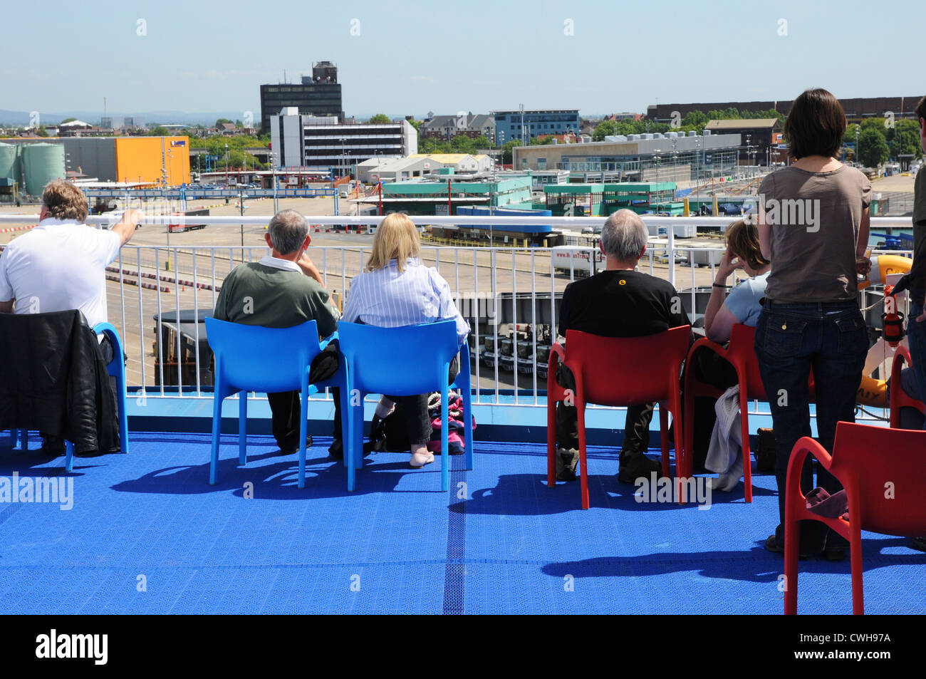 Rear view of elderly people, passengers, men, women sitting, one ...