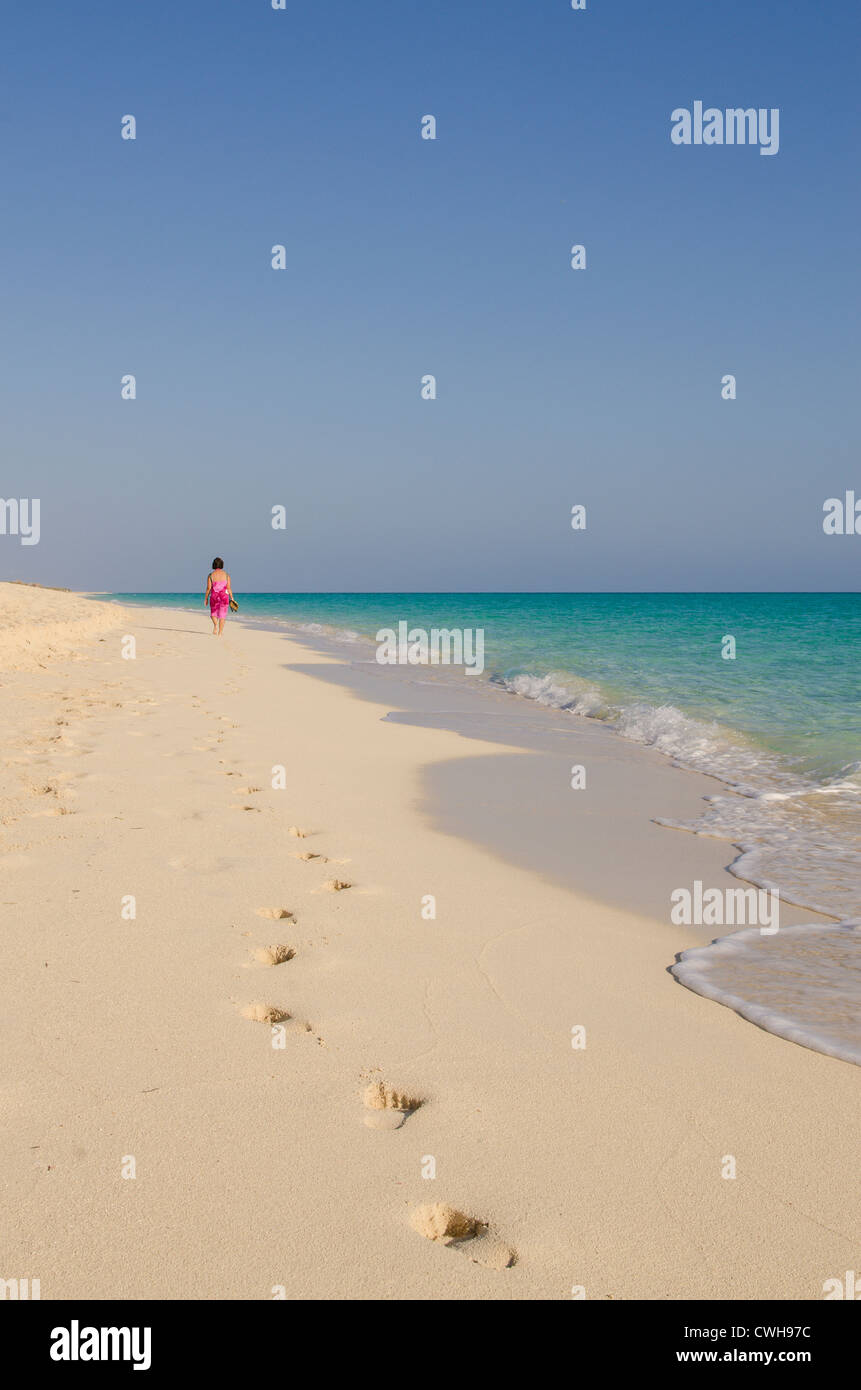Woman and footprints footsteps on beach at Sol Cayo Santa Maria Resort ...