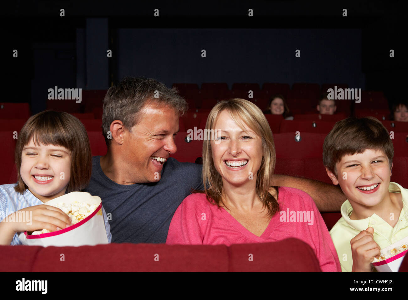 Family Watching Film In Cinema Stock Photo - Alamy