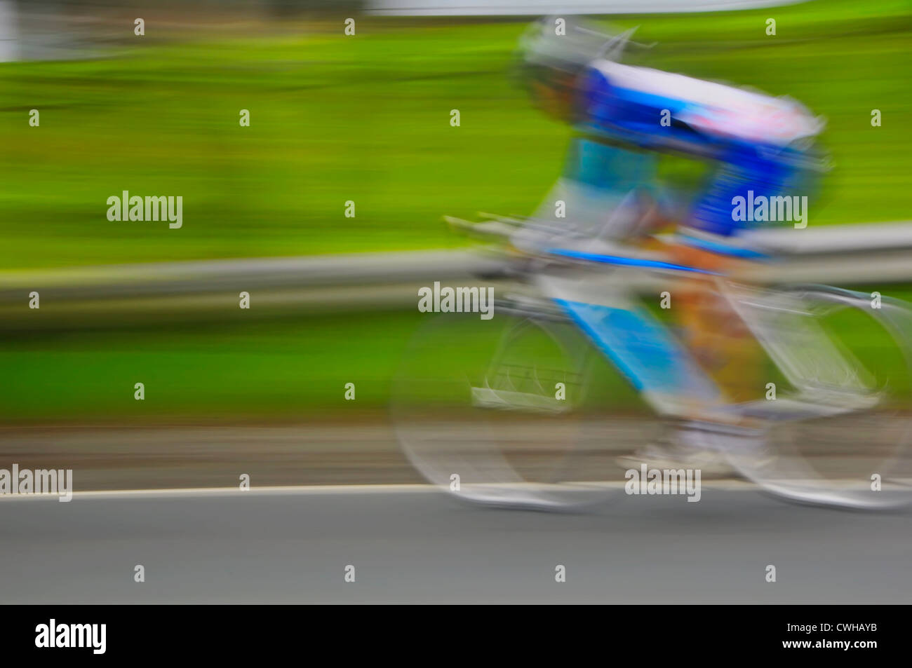 Blur of cyclist in motion Stock Photo - Alamy