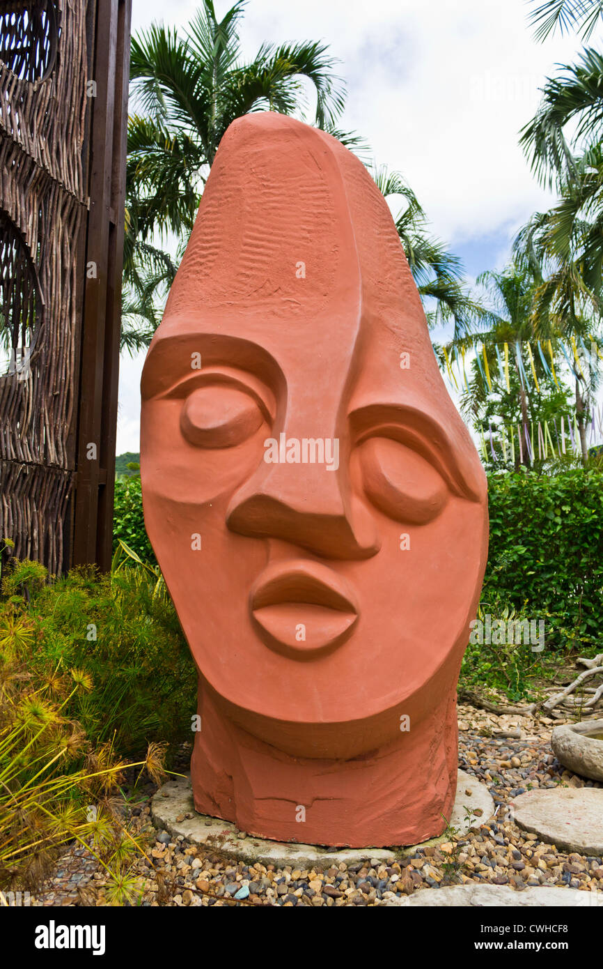 Orange Statue of Stone Head in the Garden Stock Photo - Alamy