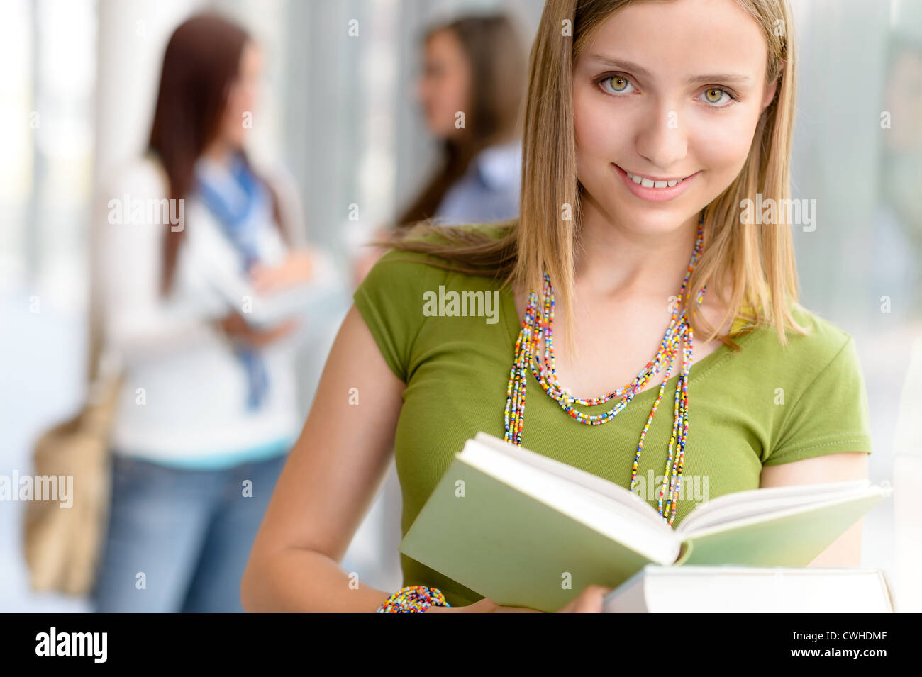 Female student reading book at high school library hall Stock Photo - Alamy