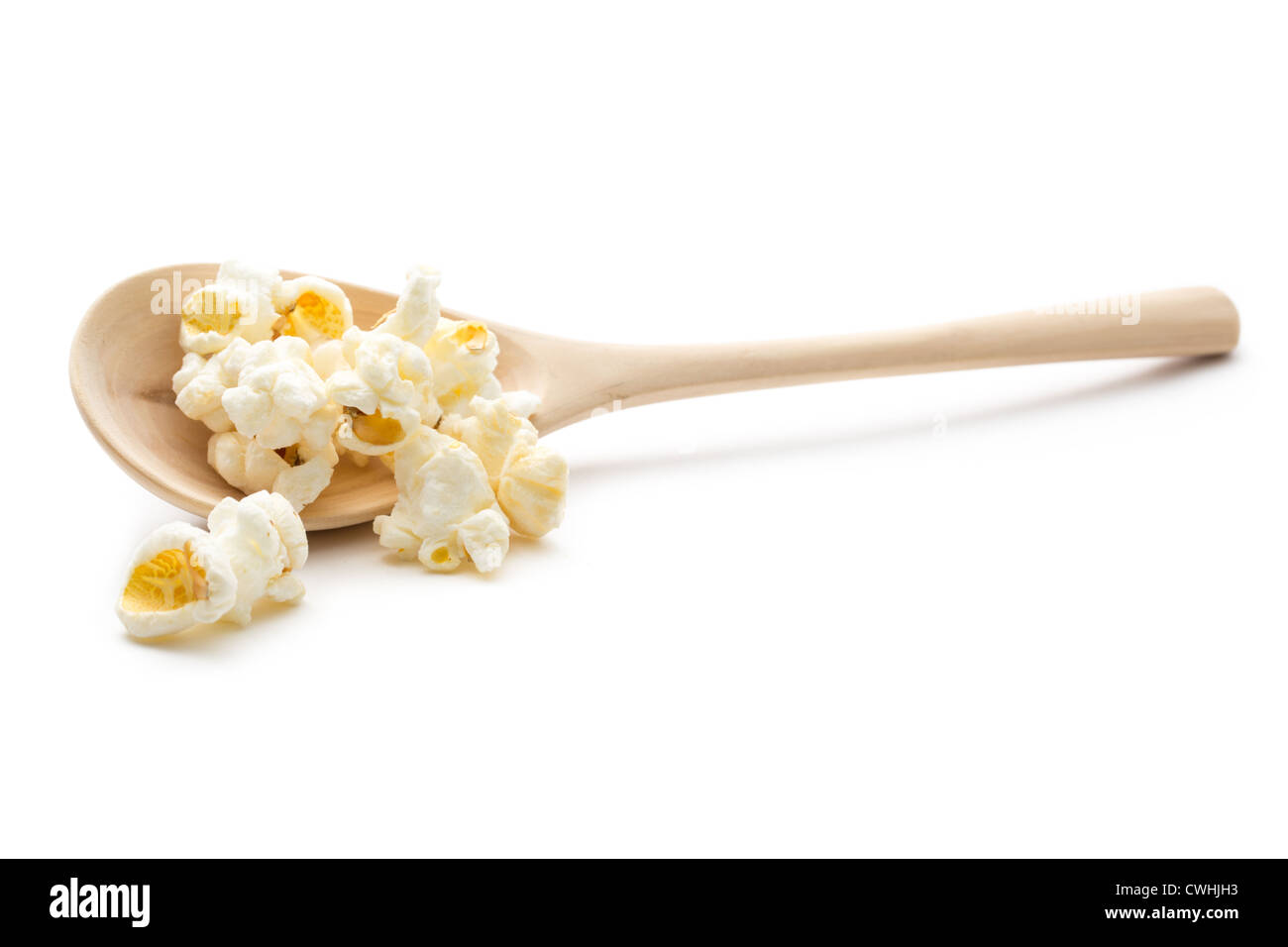 Popcorn on the wooden spoon Stock Photo - Alamy