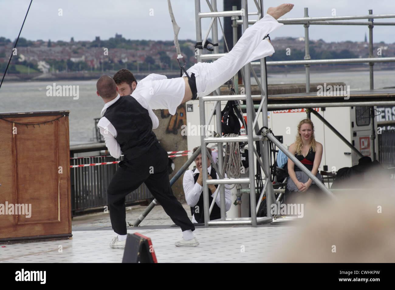 two performers and woman spectator Stock Photo - Alamy