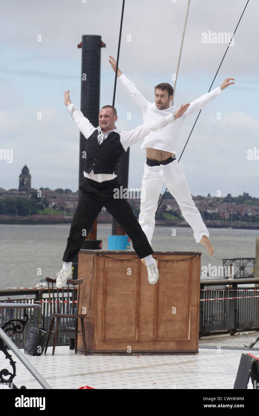 two men balancing on strings by Mersey Stock Photo - Alamy