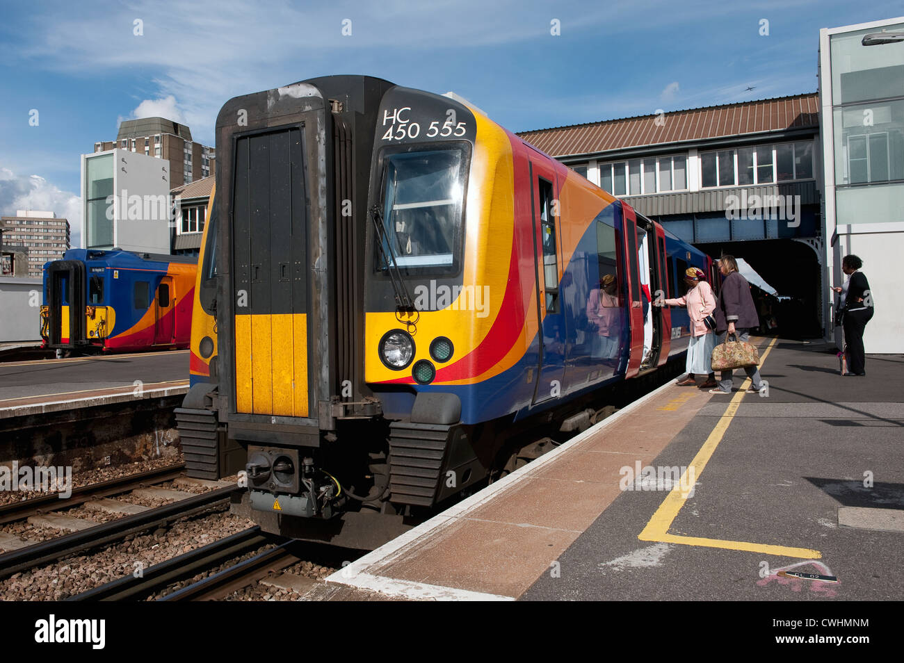 Passengers waiting to board a class 450 passenger train in South West ...
