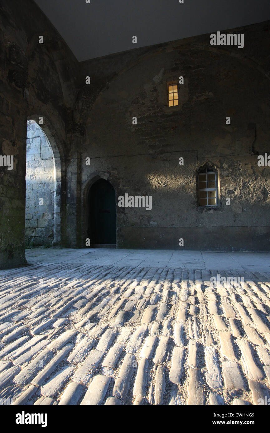 Stone arch with lit window Stock Photo - Alamy