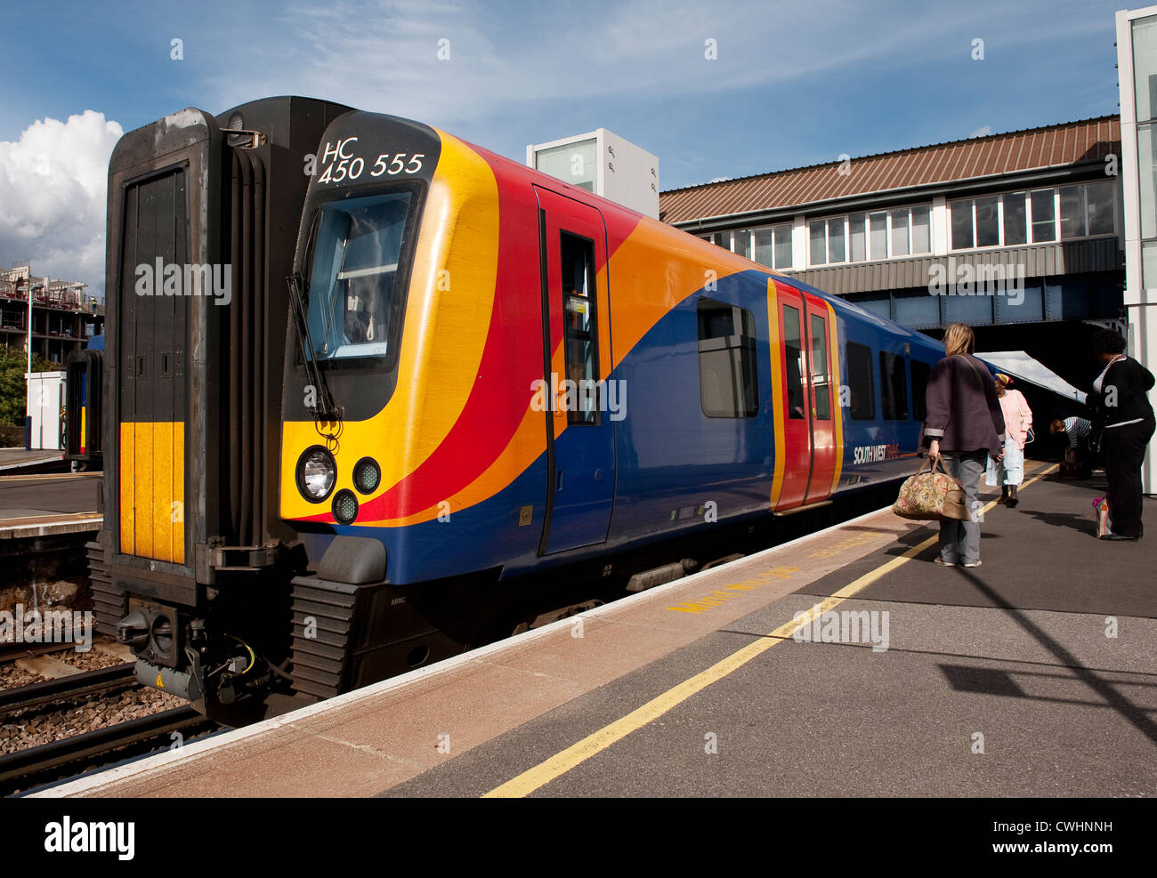 Passengers waiting to board a class 450 passenger train in South West ...