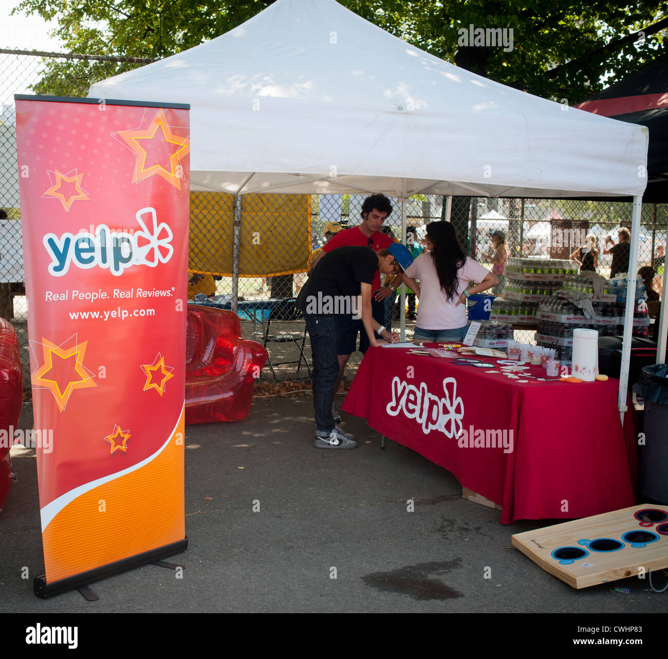 A booth promoting Yelp, the crowdsourcing review site, at a festival in ...