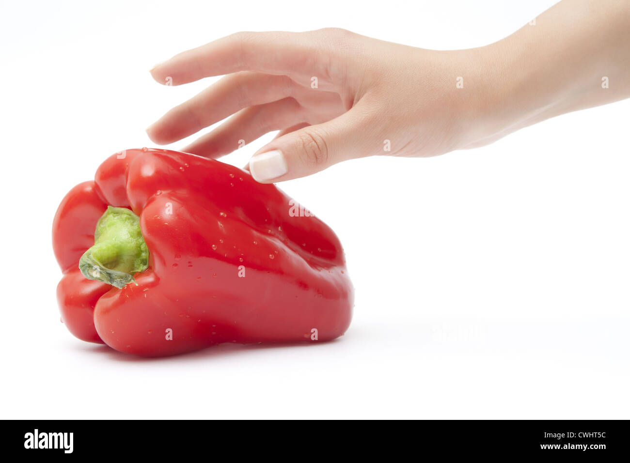 a woman hand grabbing a red bellpepper on a white background Stock ...