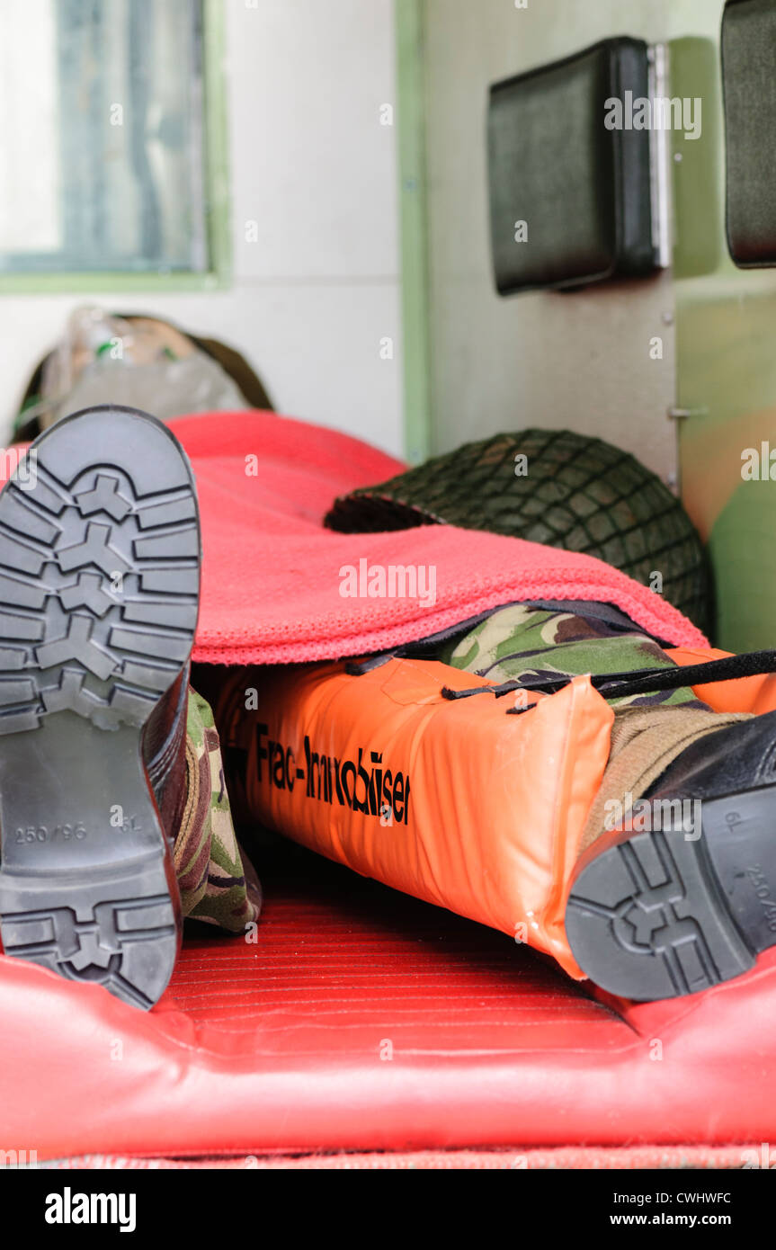 Model of a soldier lying in the back of a military ambulance with a leg ...