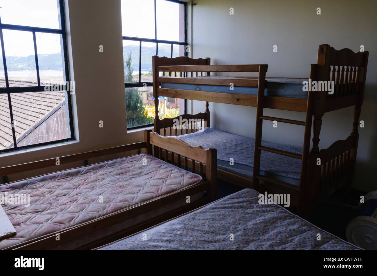 Four beds in a cramped bedroom Stock Photo - Alamy
