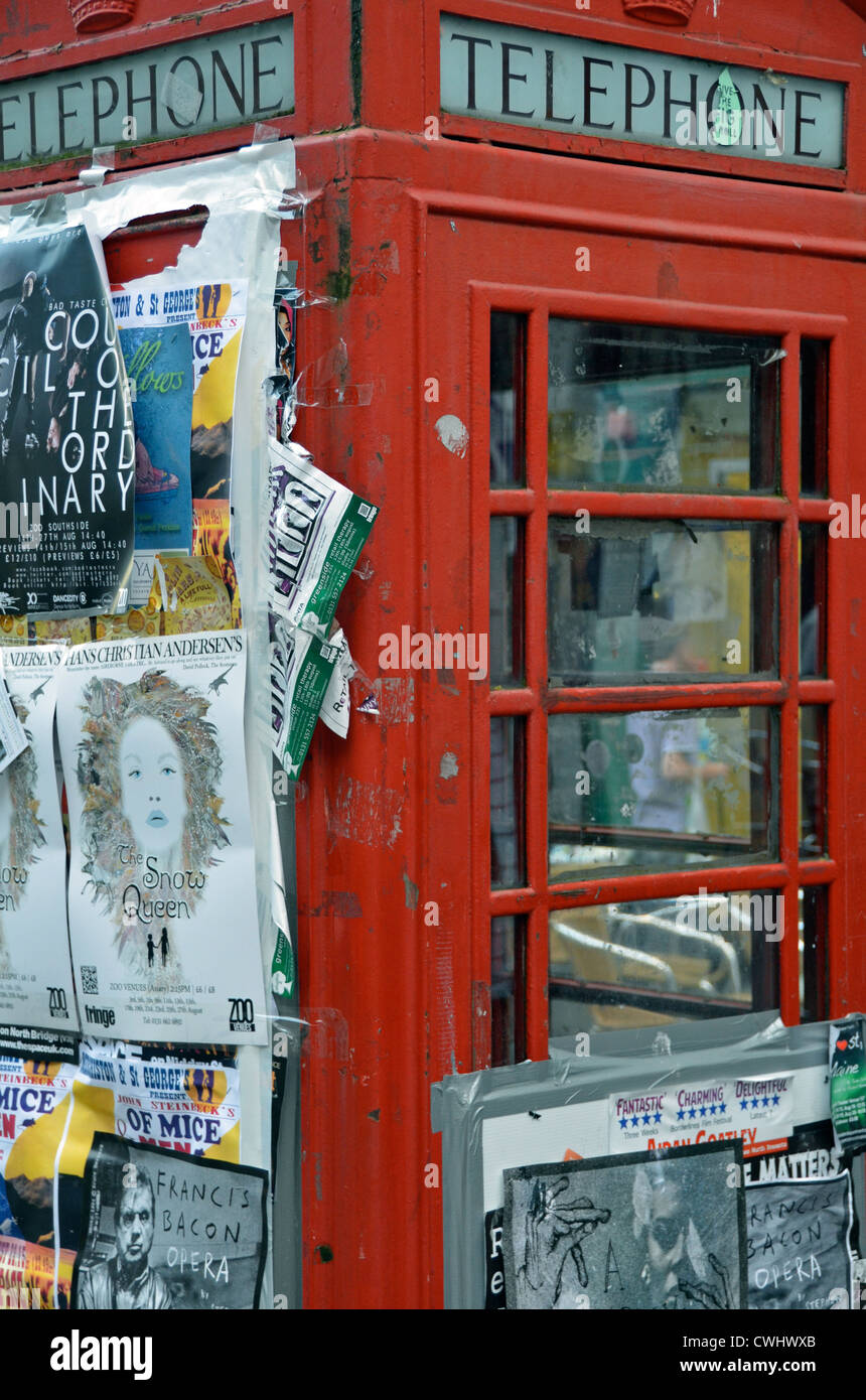 Red telephone box with posters, Edinburgh Stock Photo - Alamy