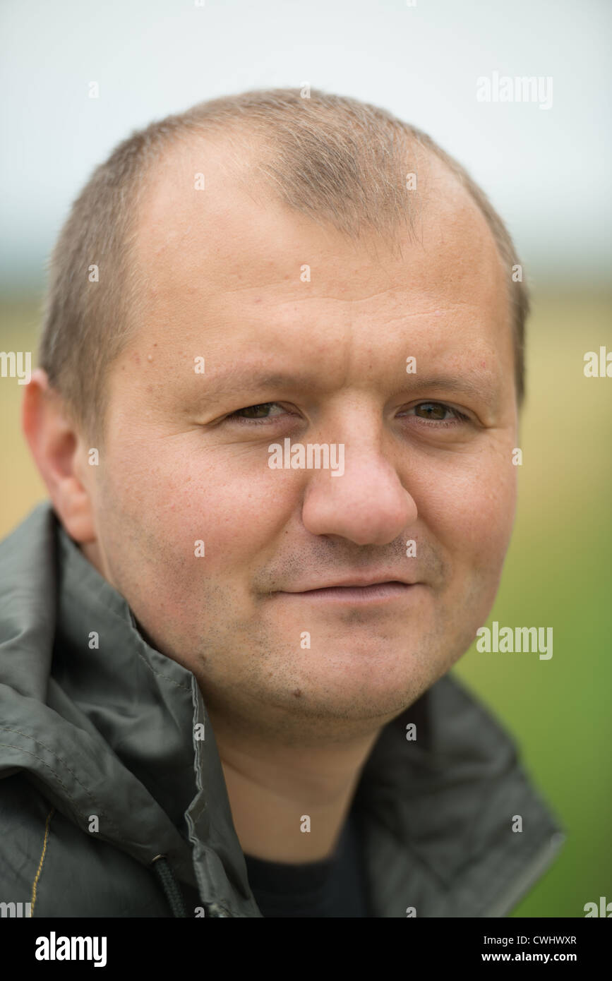 portrait of a young bald Man wearing rain jacket Stock Photo - Alamy