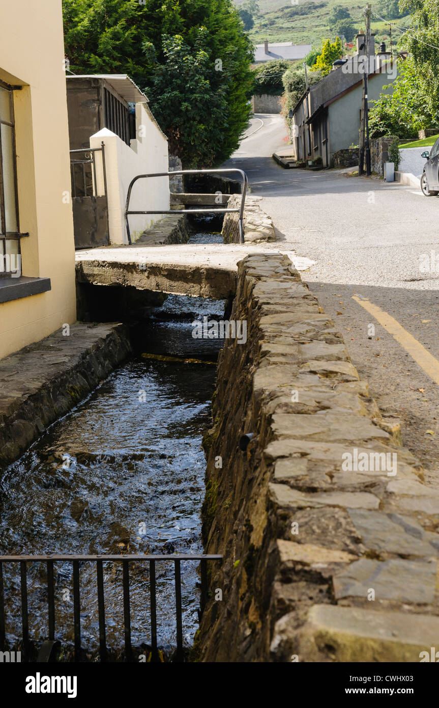 Stream running down the side of a street in Carlingford village Stock ...