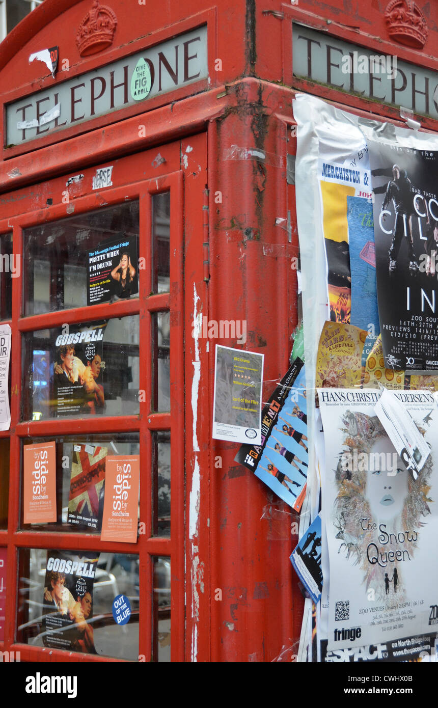 Red telephone box with posters, Edinburgh Stock Photo - Alamy