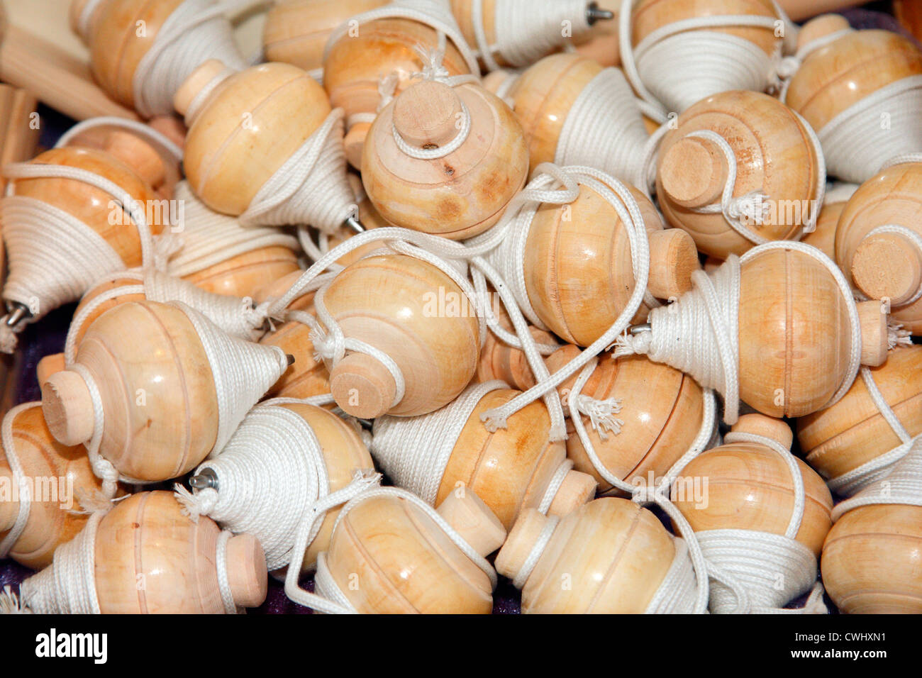 Pile of wooden tops with string Stock Photo - Alamy