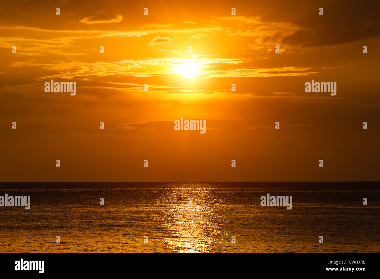 Sunset in the sea with soft wave and cloudy Stock Photo - Alamy