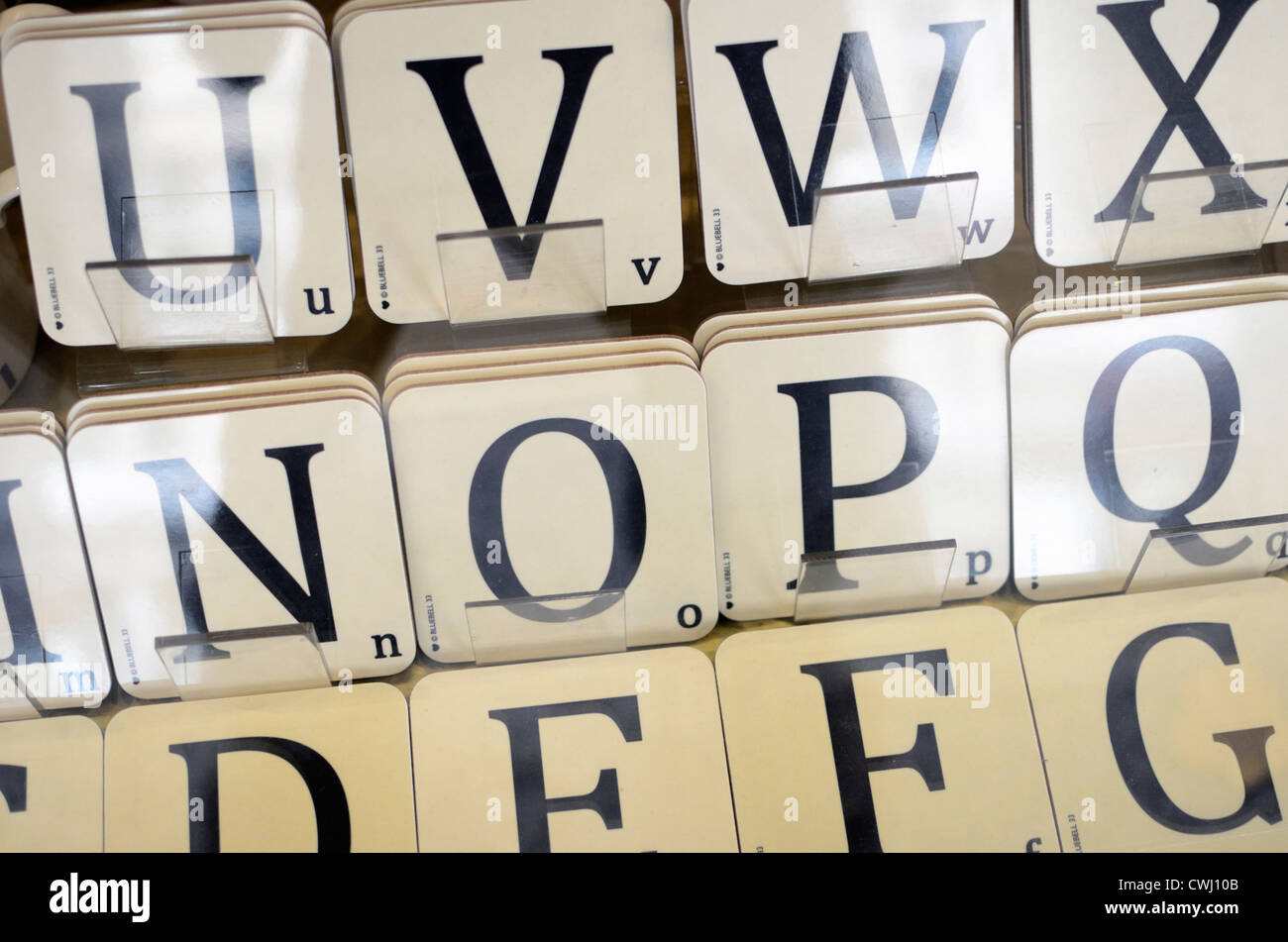 Letters of the alphabet on placemats in a shop window Stock Photo - Alamy
