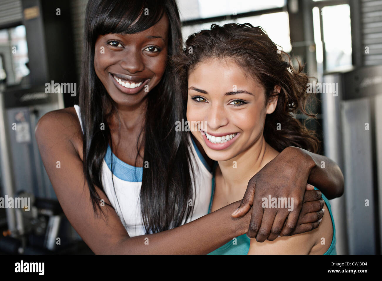 Smiling women hugging in health club Stock Photo - Alamy