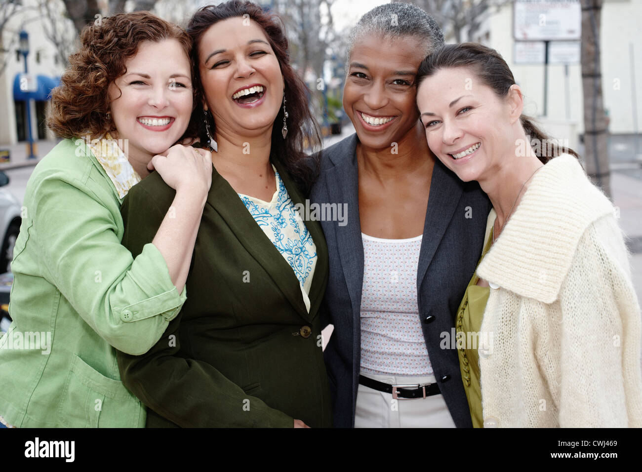 Smiling friends standing together Stock Photo - Alamy