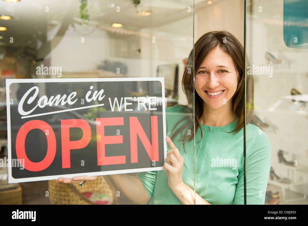 Woman shop open sign hi-res stock photography and images - Alamy