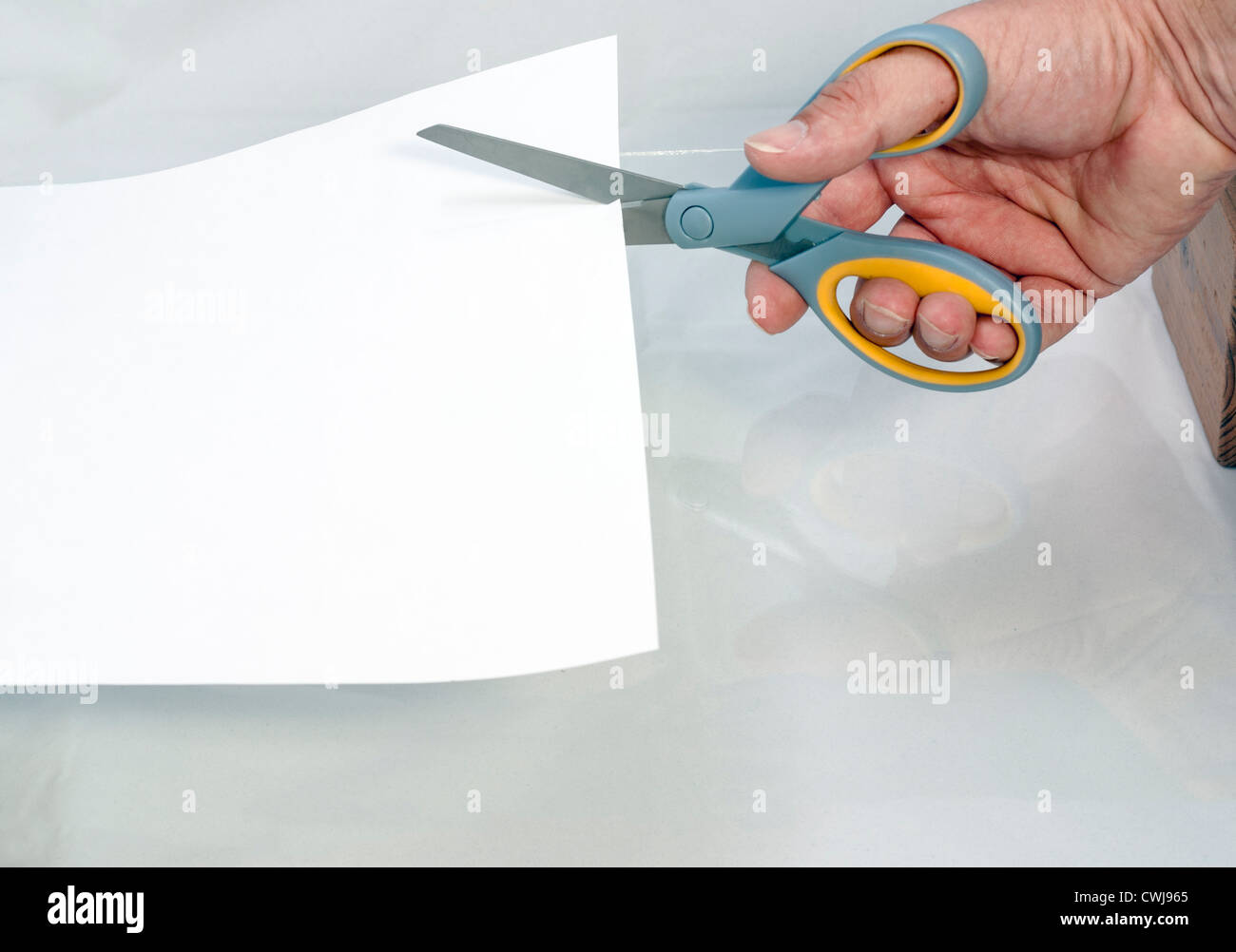 Scissors are used to cut paper Stock Photo - Alamy