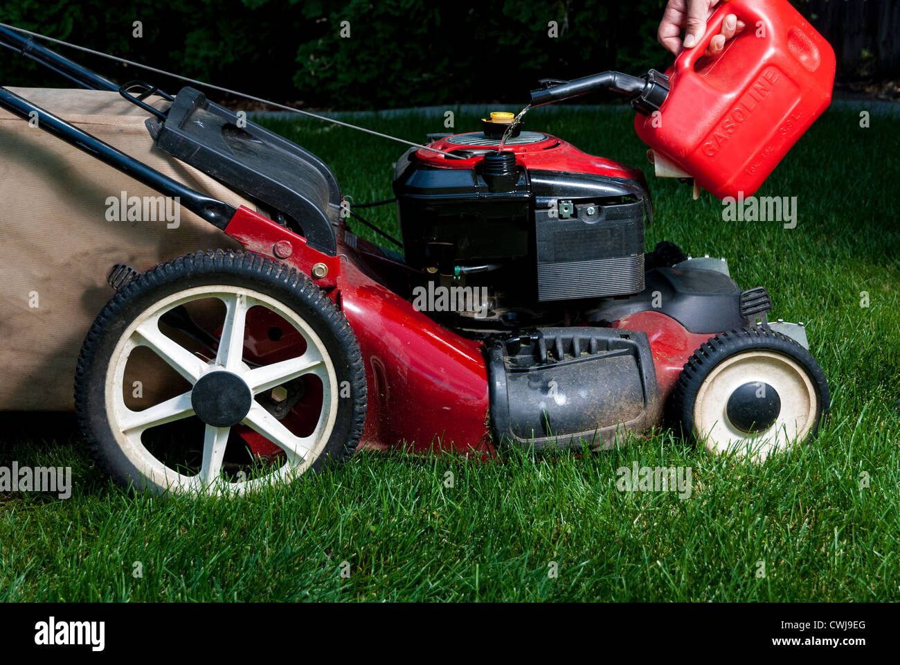 Lawn mower is getting some gas Stock Photo - Alamy