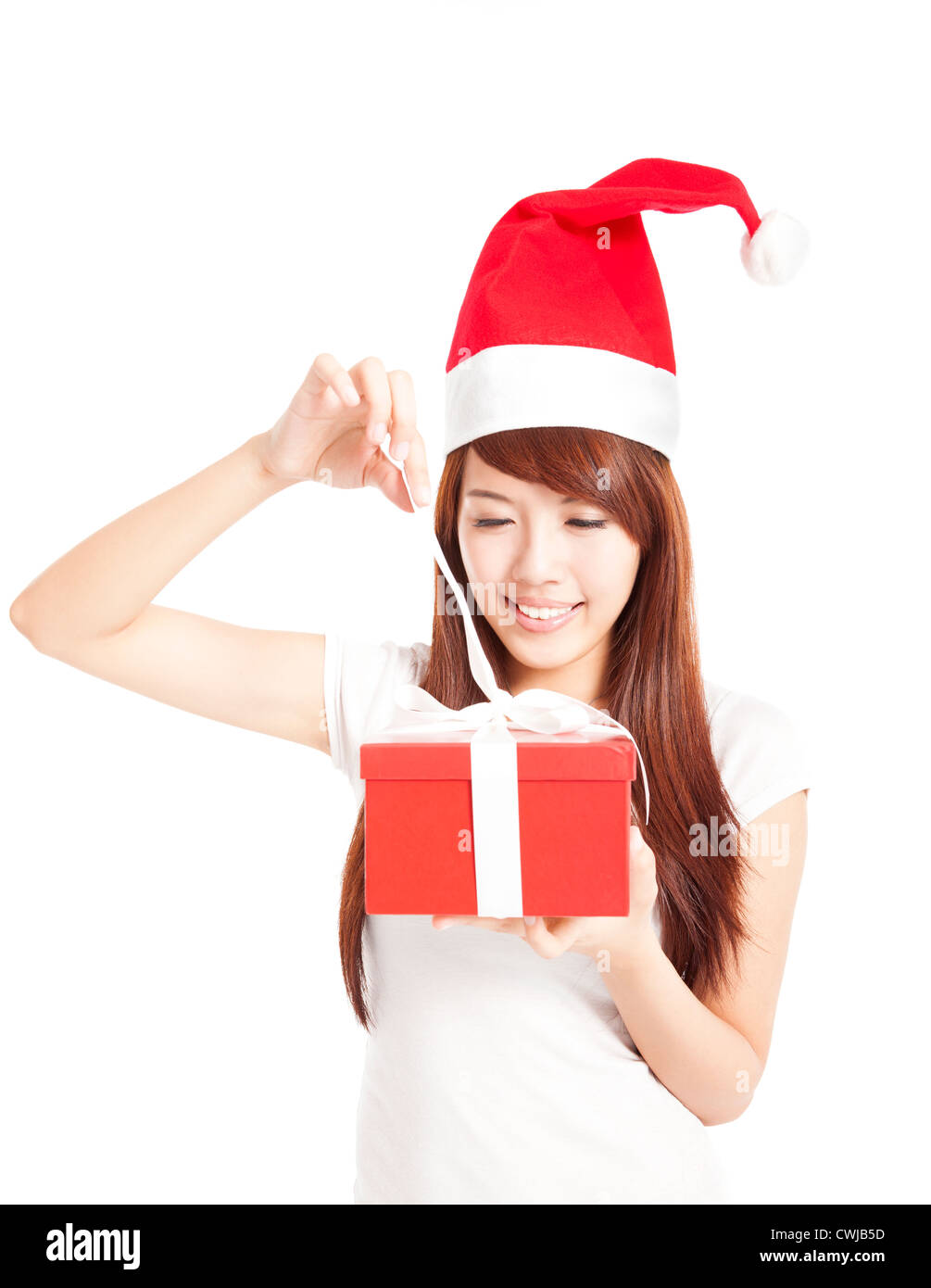 young woman trying to open christmas gift box Stock Photo - Alamy