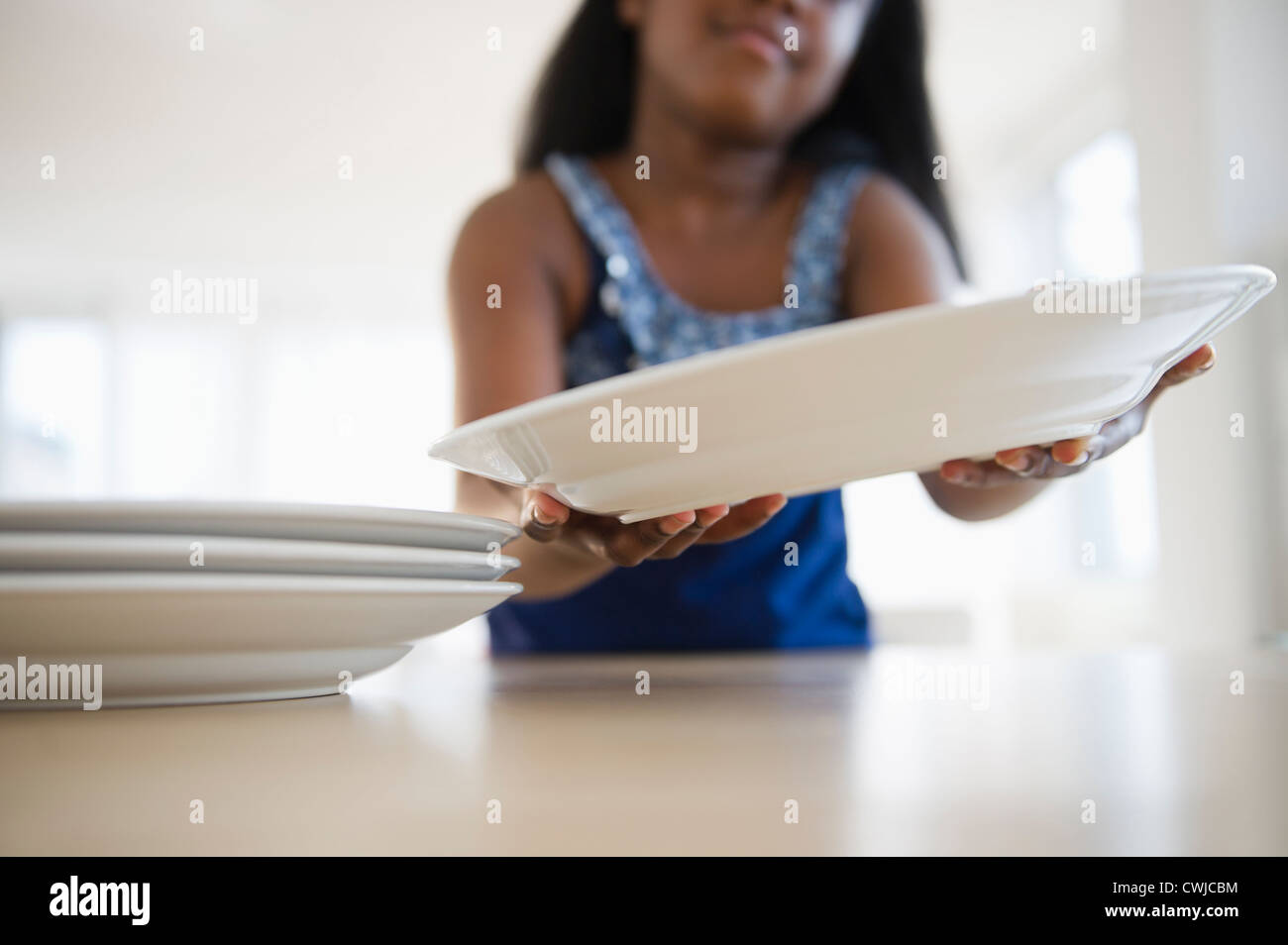 Black girl setting the table Stock Photo - Alamy