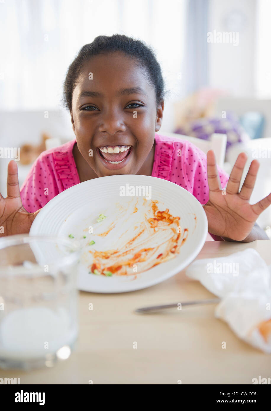 Black girl holding empty plate Stock Photo - Alamy
