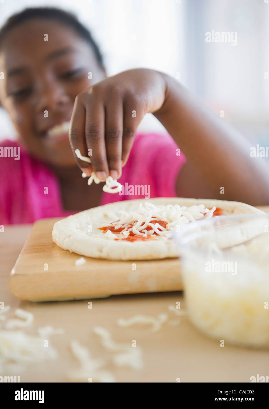 Black girl making pizza Stock Photo - Alamy