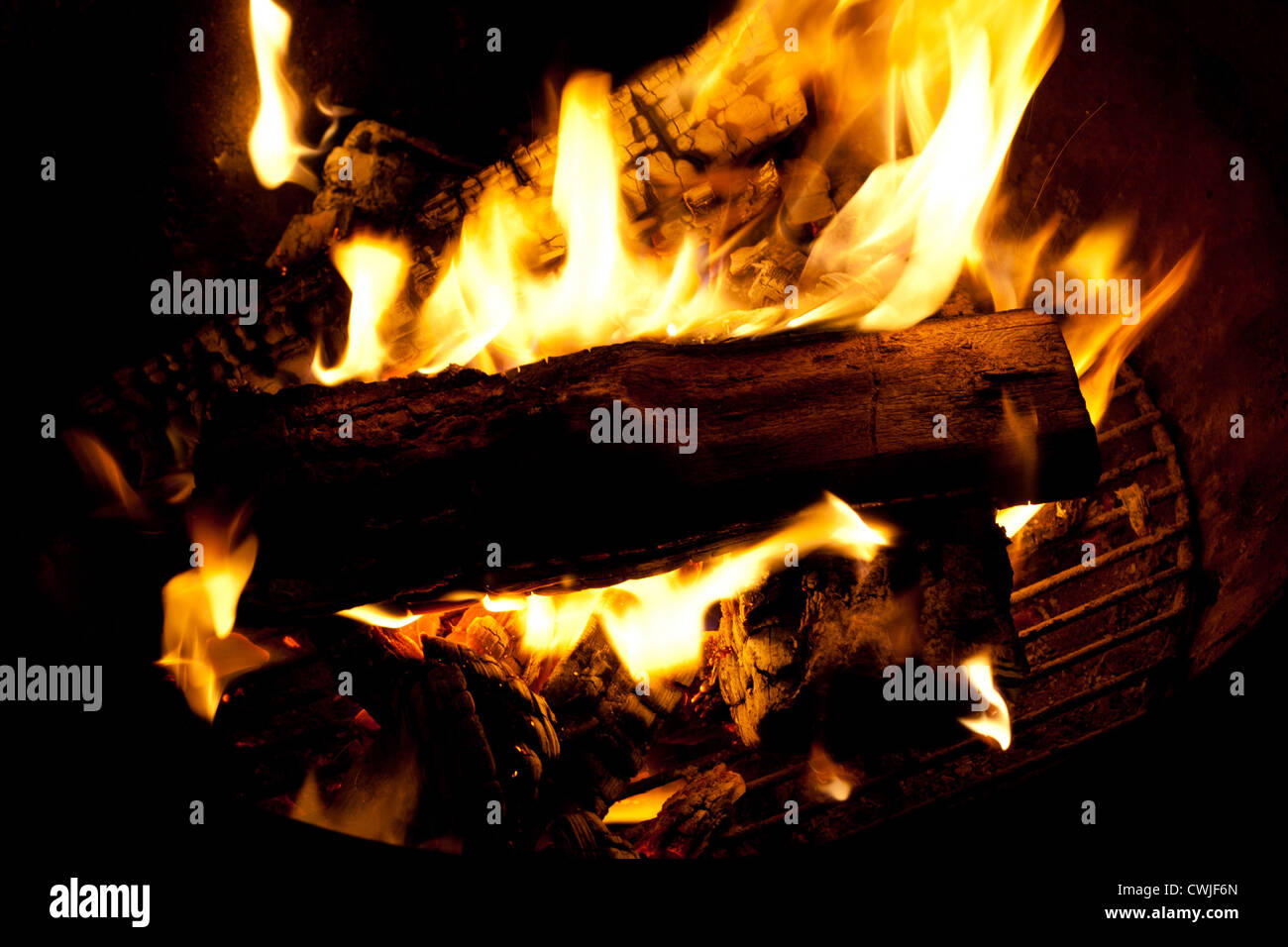Some pieces of wood burning in a camp fire in Austria Stock Photo - Alamy