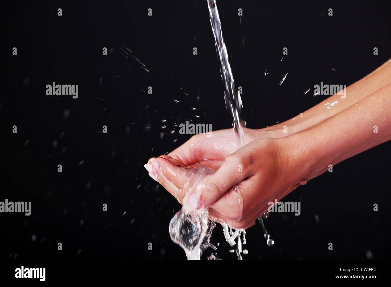 Water splashing on female hands, over black background Stock Photo - Alamy
