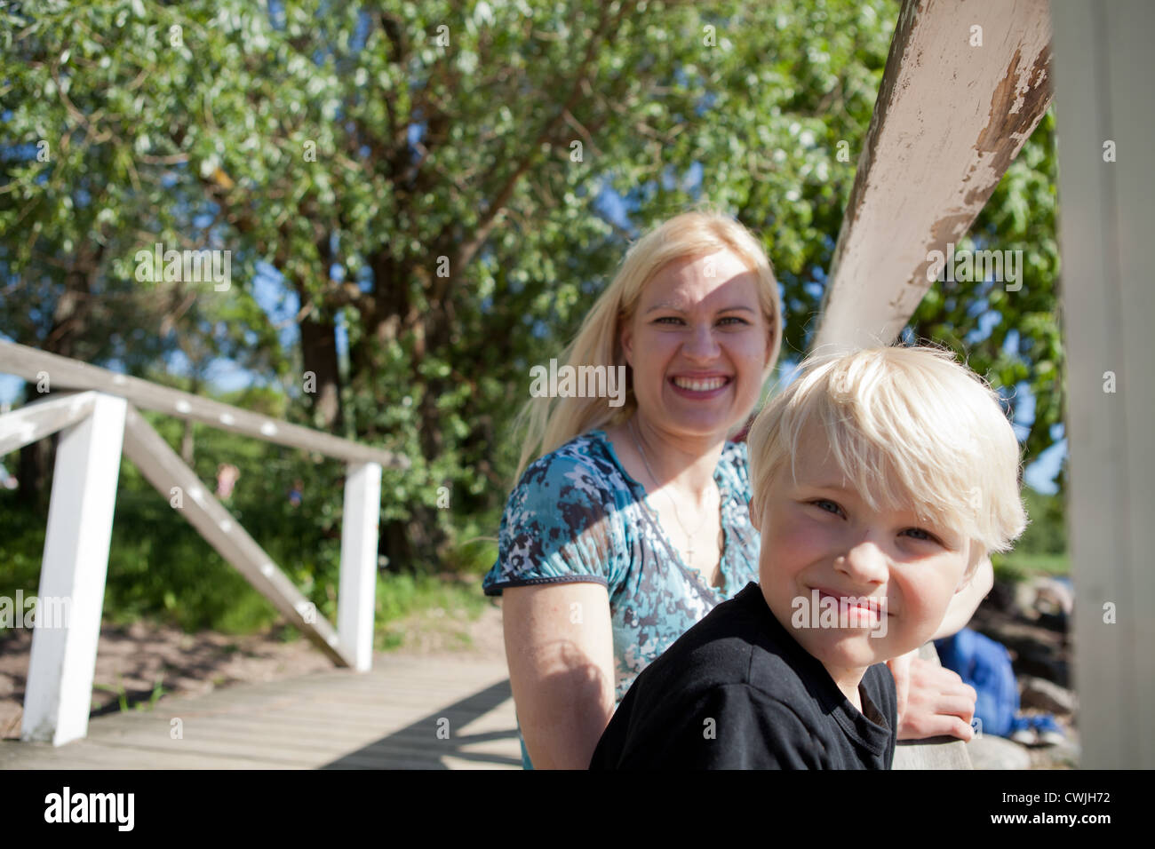 Portrait of a boy outdoors with his mother in the background Stock ...