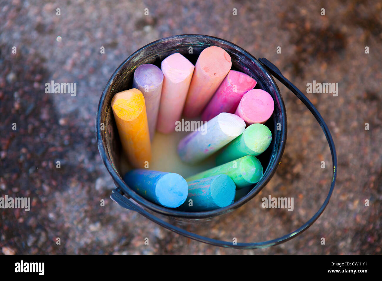 Bucket of colorful crayons outdoors for drawing Stock Photo - Alamy