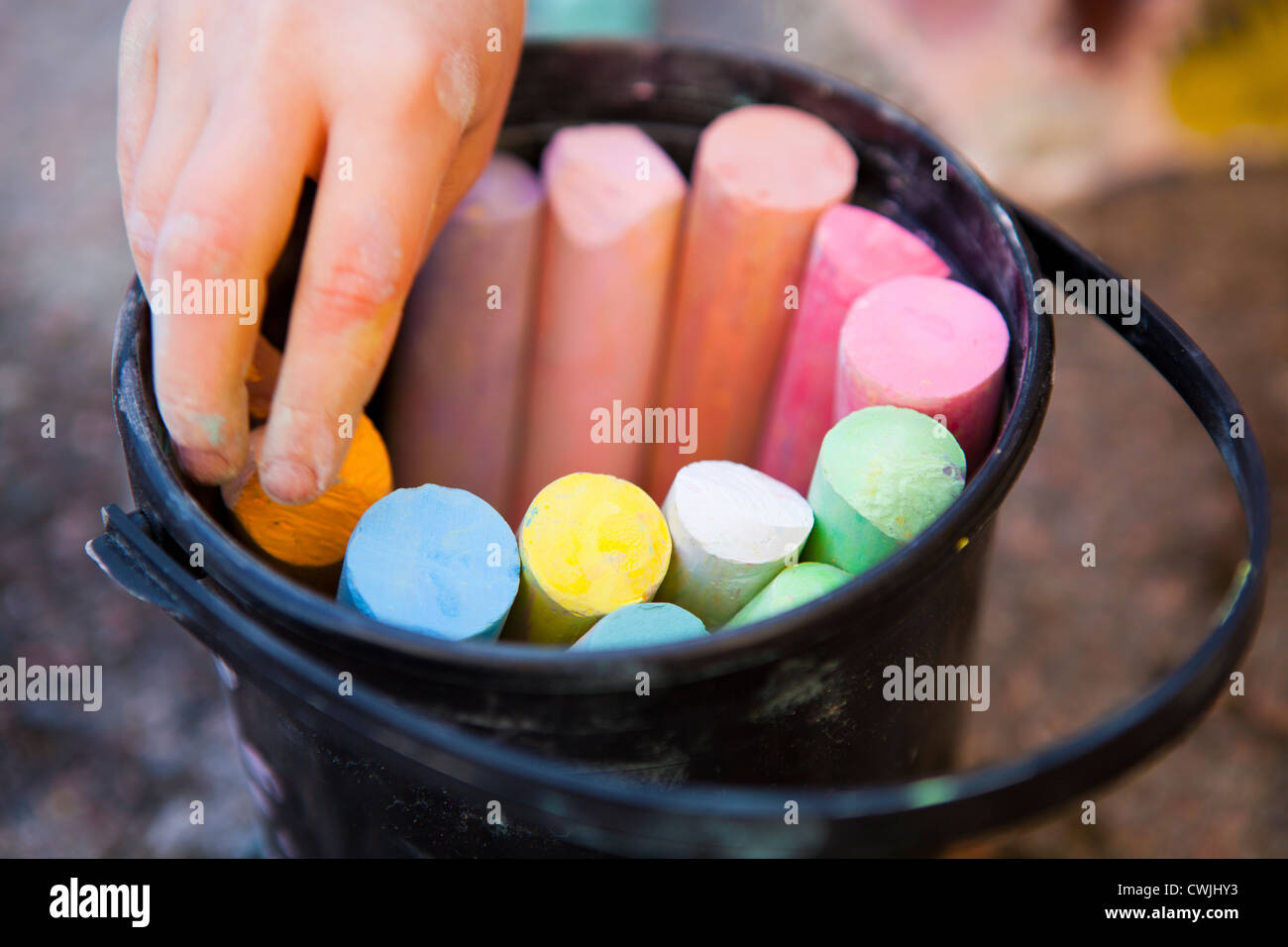 Bucket of colorful crayons outdoors for drawing Stock Photo - Alamy