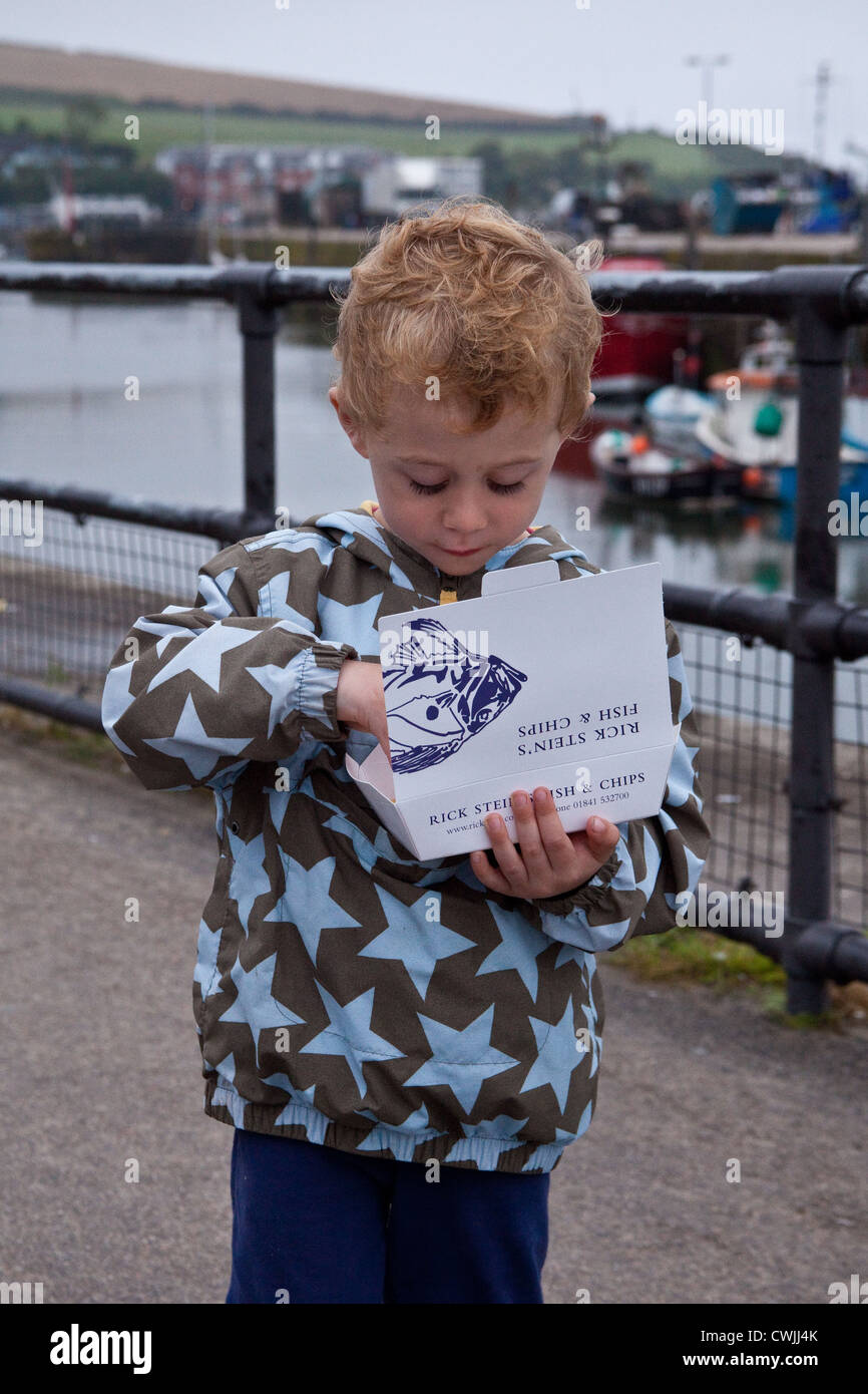 Three year old boy eating fish and chips from Rick Steins fish and chip ...