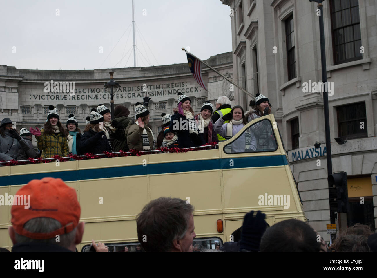 Looking up at an open topped bus in the New Years Day parade with ...